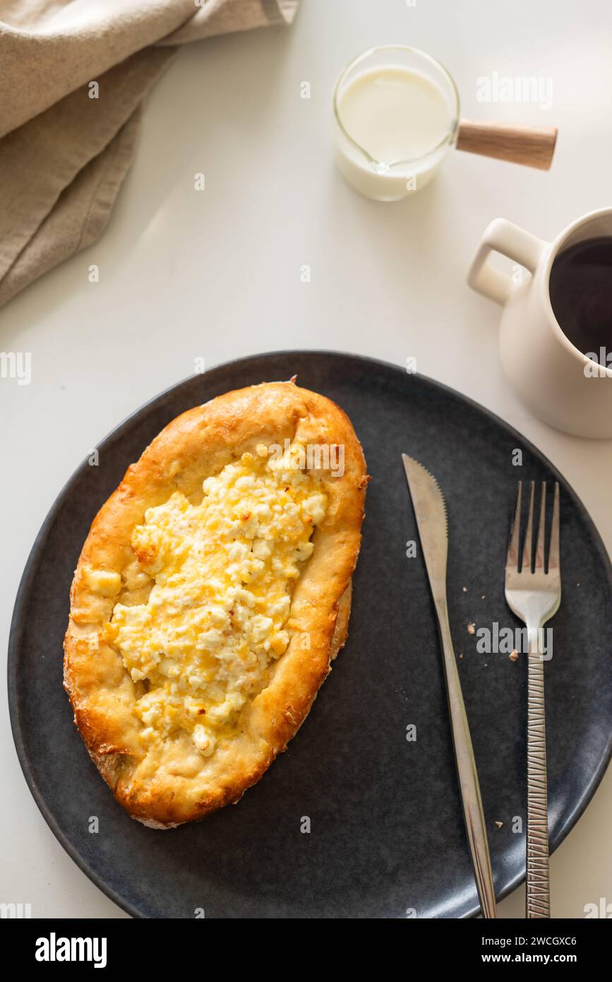 traditional Georgian cuisine. Open pie with mozzarella cheese. Ajara ...
