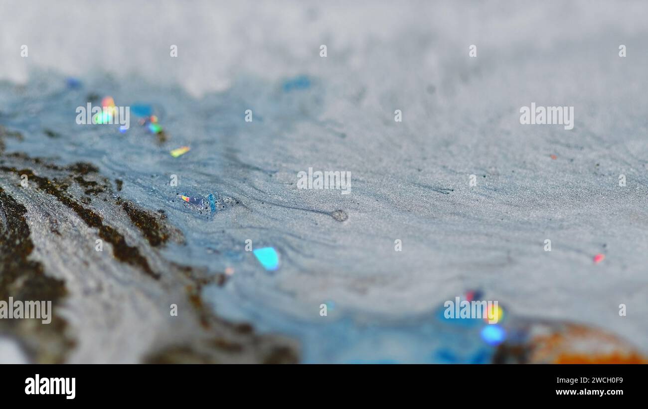 Glitter paint wave sparkling fluid flow blue spill Stock Photo - Alamy