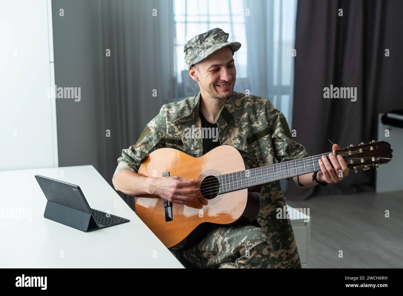 Soldier playing the guitar hi-res stock photography and images - Alamy