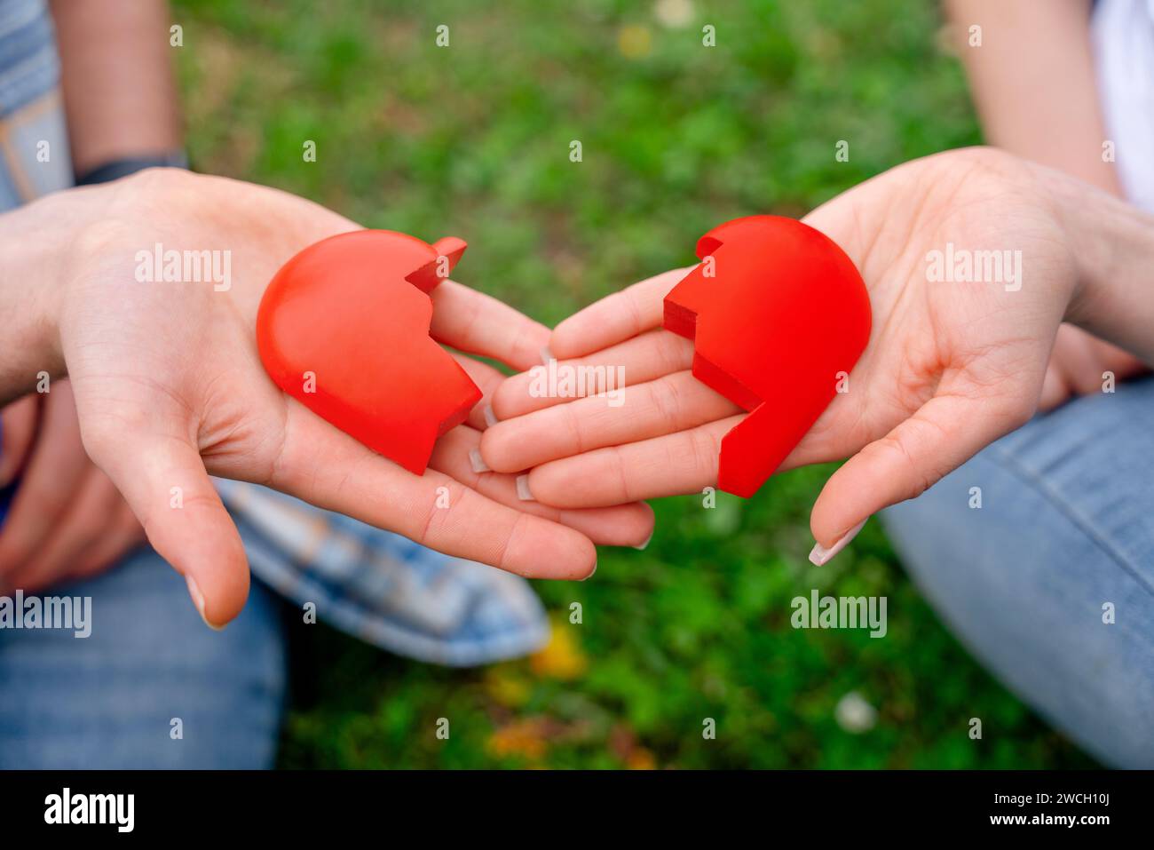 Couple trying to connect two pieces of heart - relationship, in love or ...