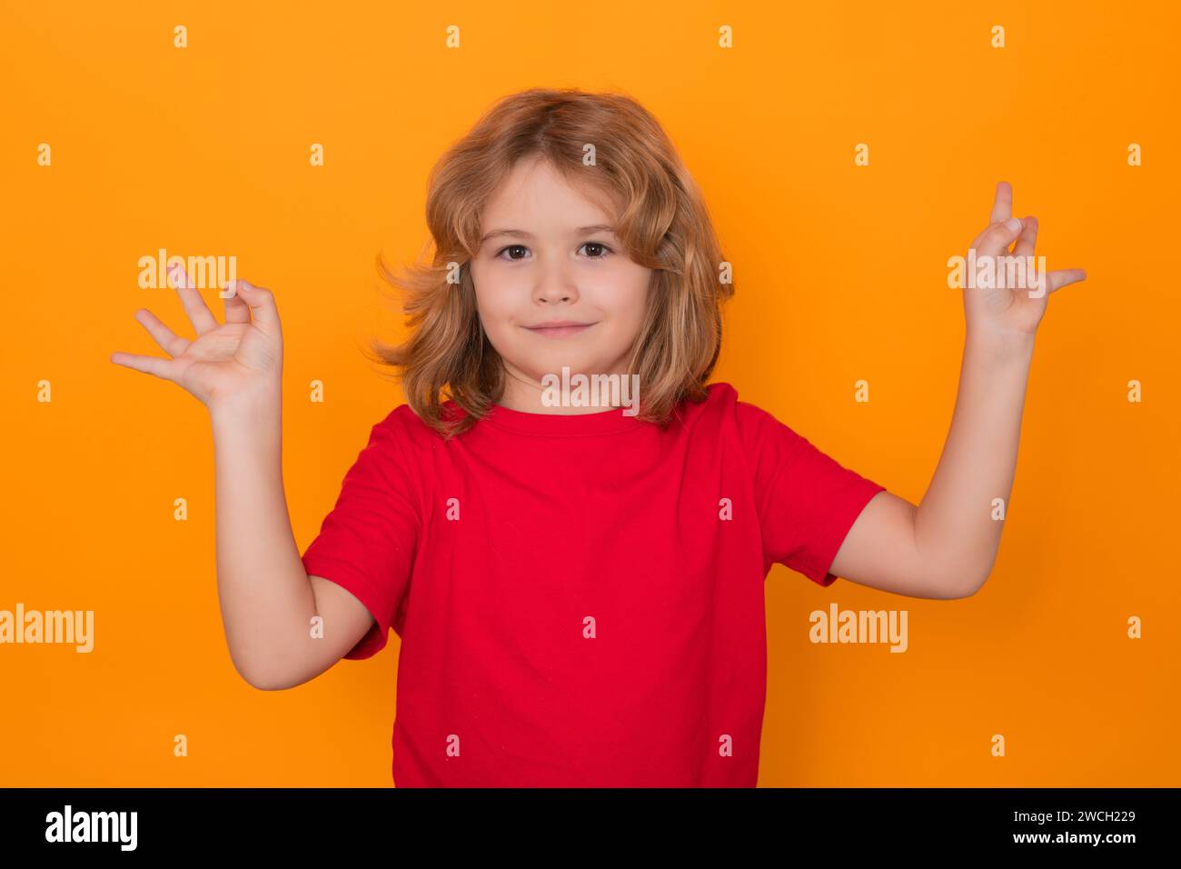 Child sign ok, okay gesture on isolated studio background. Happy kid ...