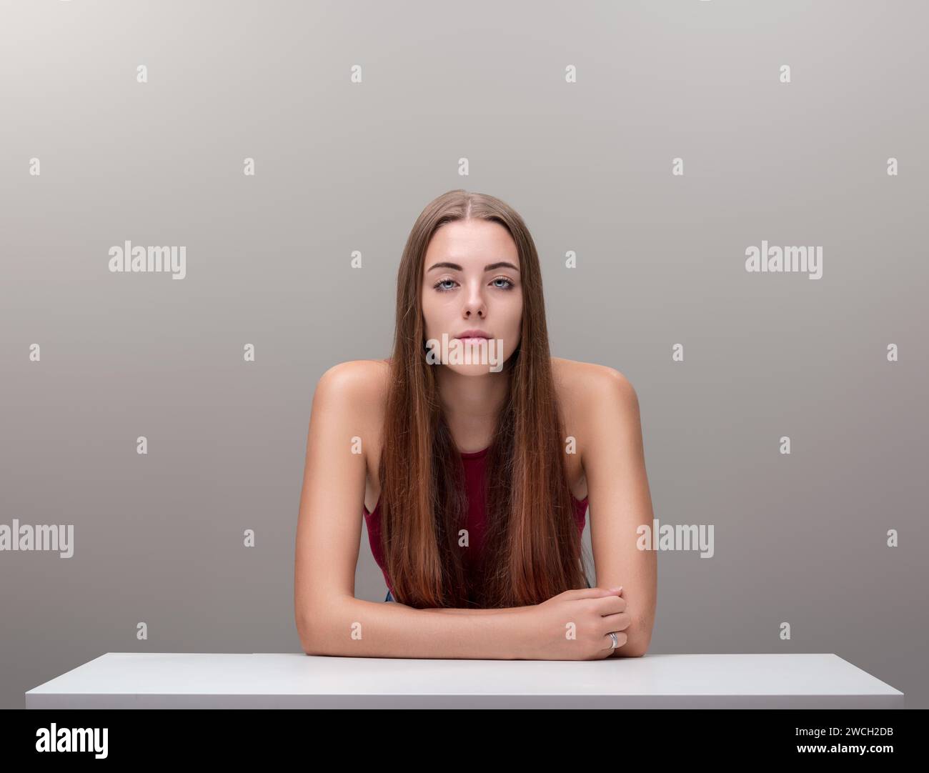 Stunning young woman with swimmer's shoulders and long hair leans ...