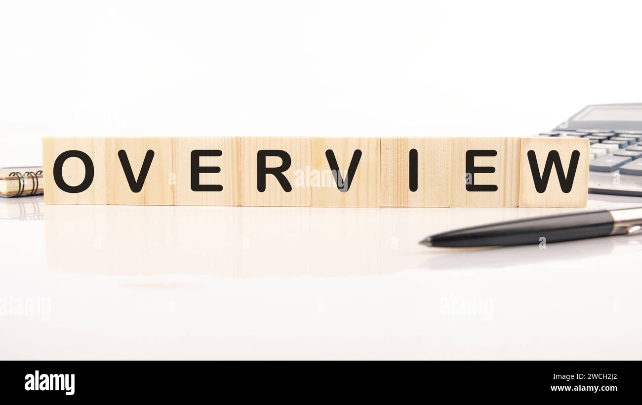 Overview word assembled from wooden cubes next to a calculator, pen and ...