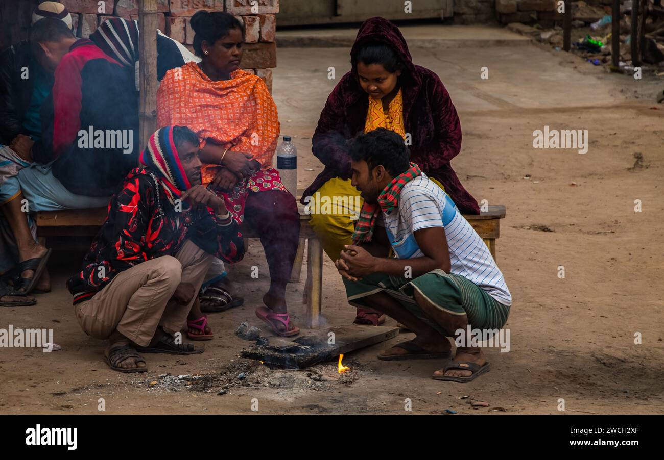 Amidst winter's chill, street people gather around a flickering fire ...