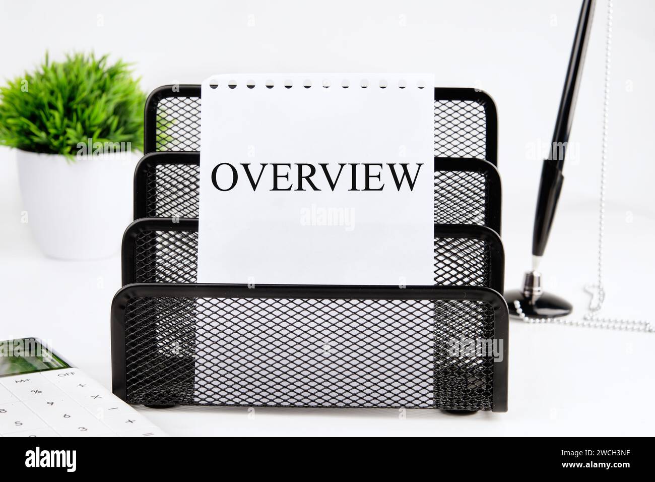 OVERVIEW A word written on a piece of paper from a notebook on a stand ...