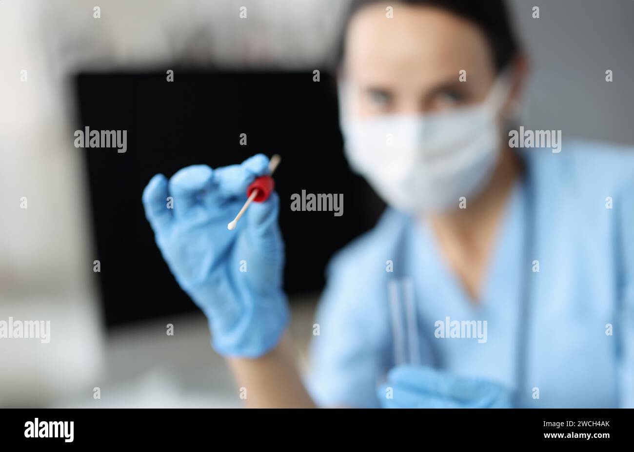 Doctor in medical protective mask holds shelf with test tube for ...