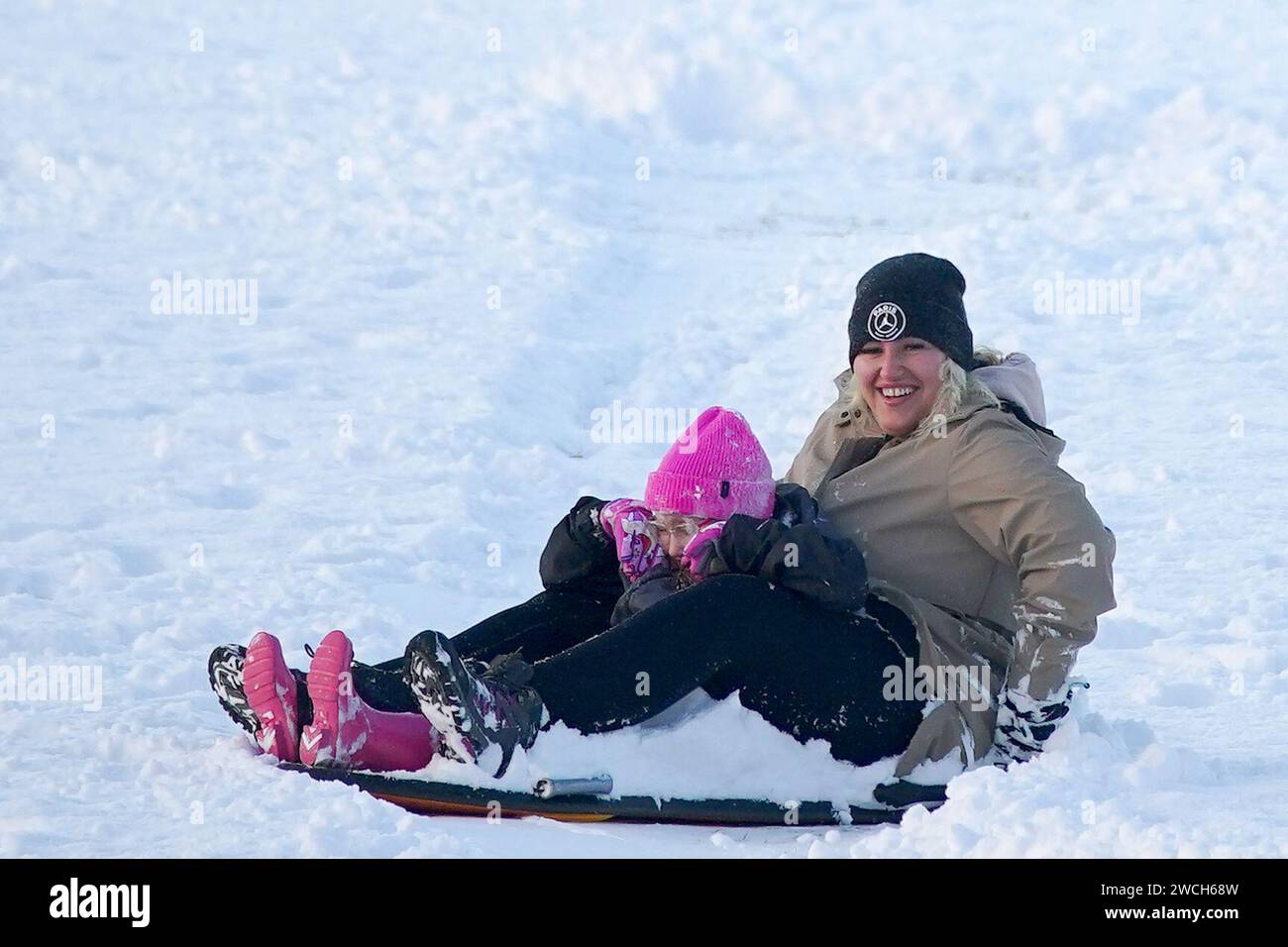 A woman and child on a sledge at Camp Hill in Woolton, Liverpool. Much ...