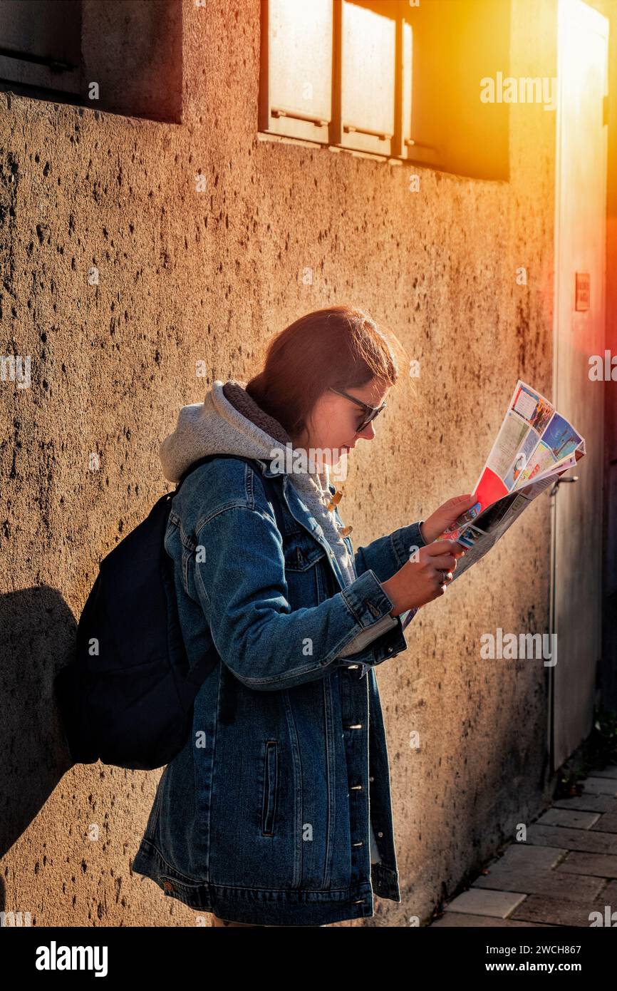 Traveler girl with backpack exploring map, active lifestyle, summer fun ...