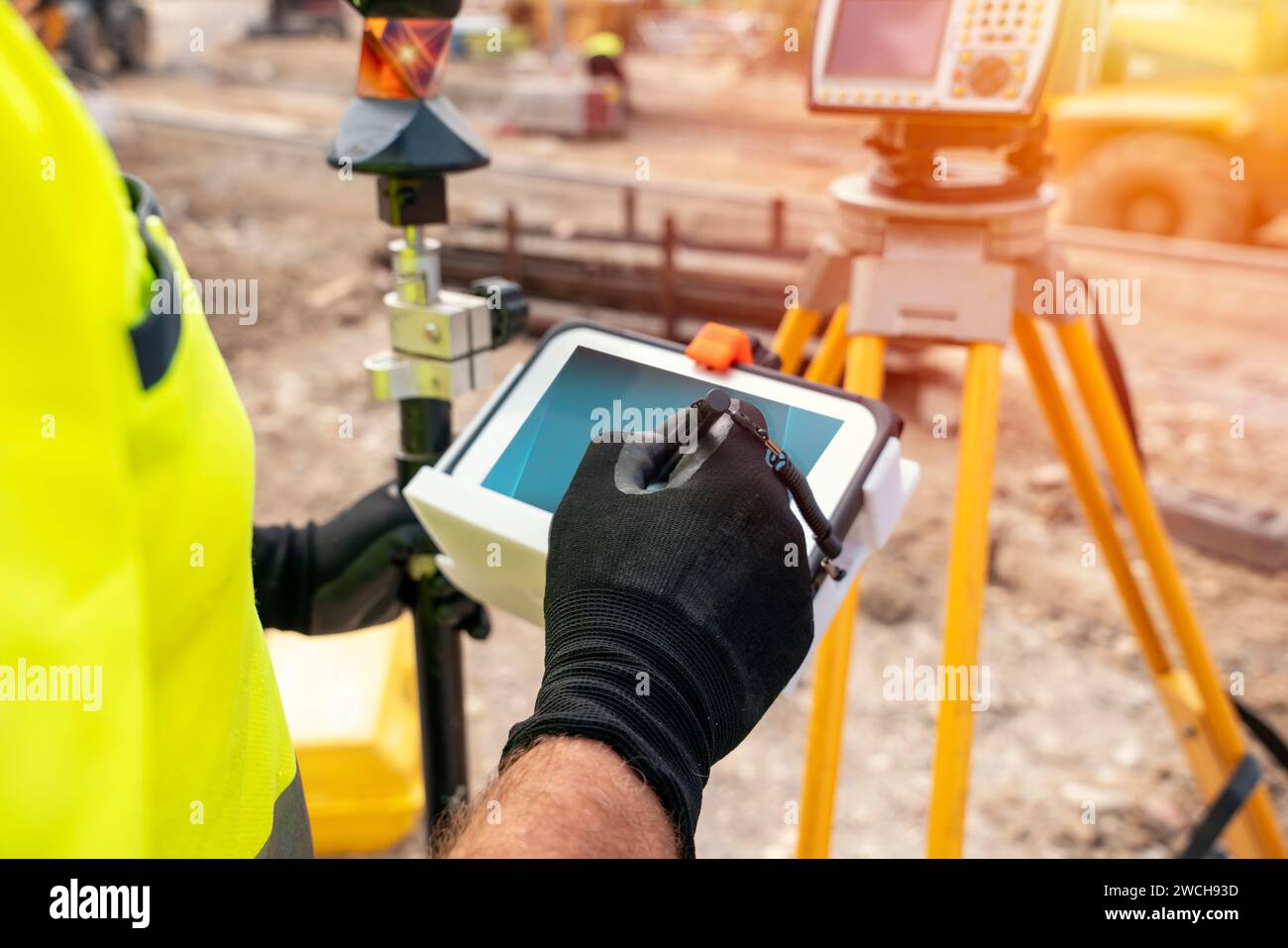 Site engineer surveyor using rugged tablet controller computer to ...
