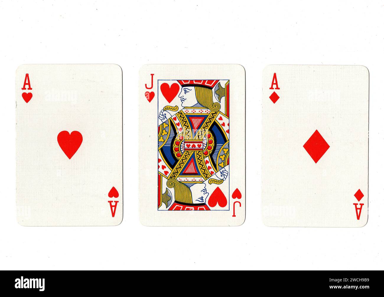 Vintage playing cards showing a pair of red aces and a red jack ...