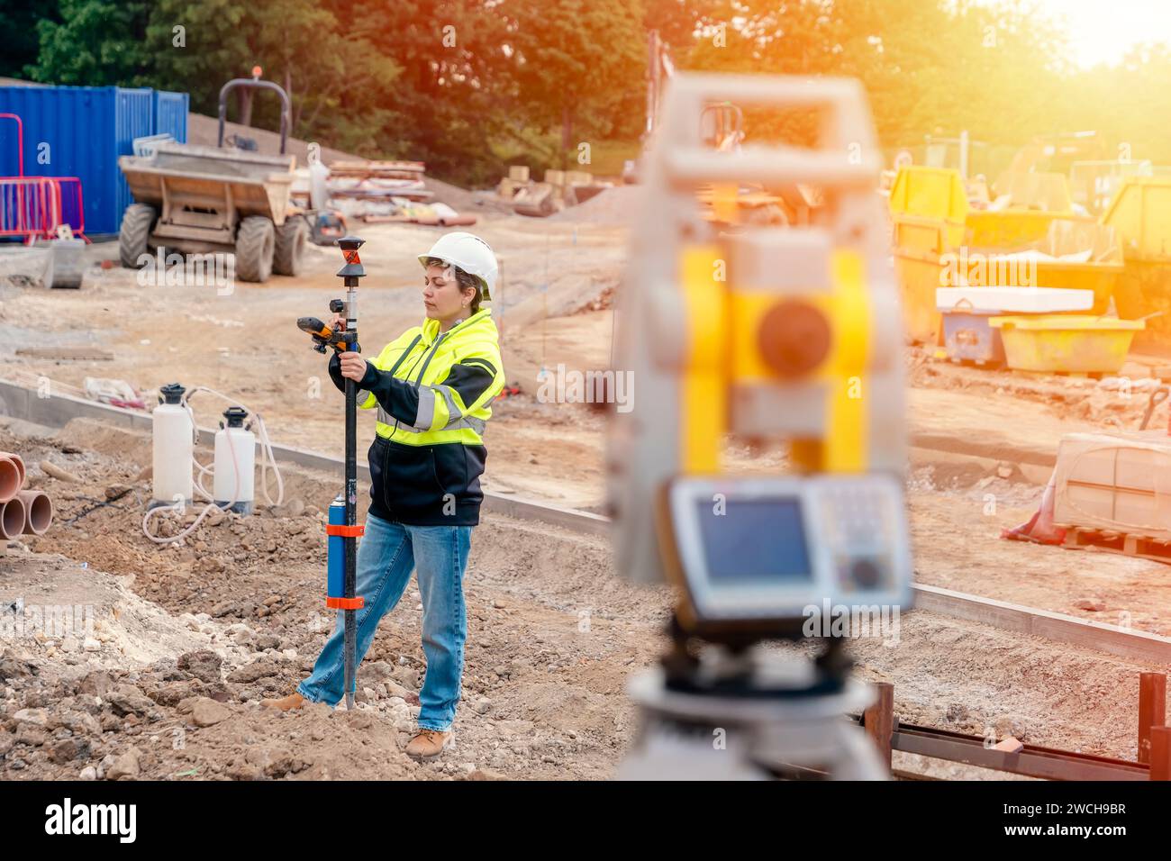 Female site engineer surveyor working with theodolite total station EDM ...