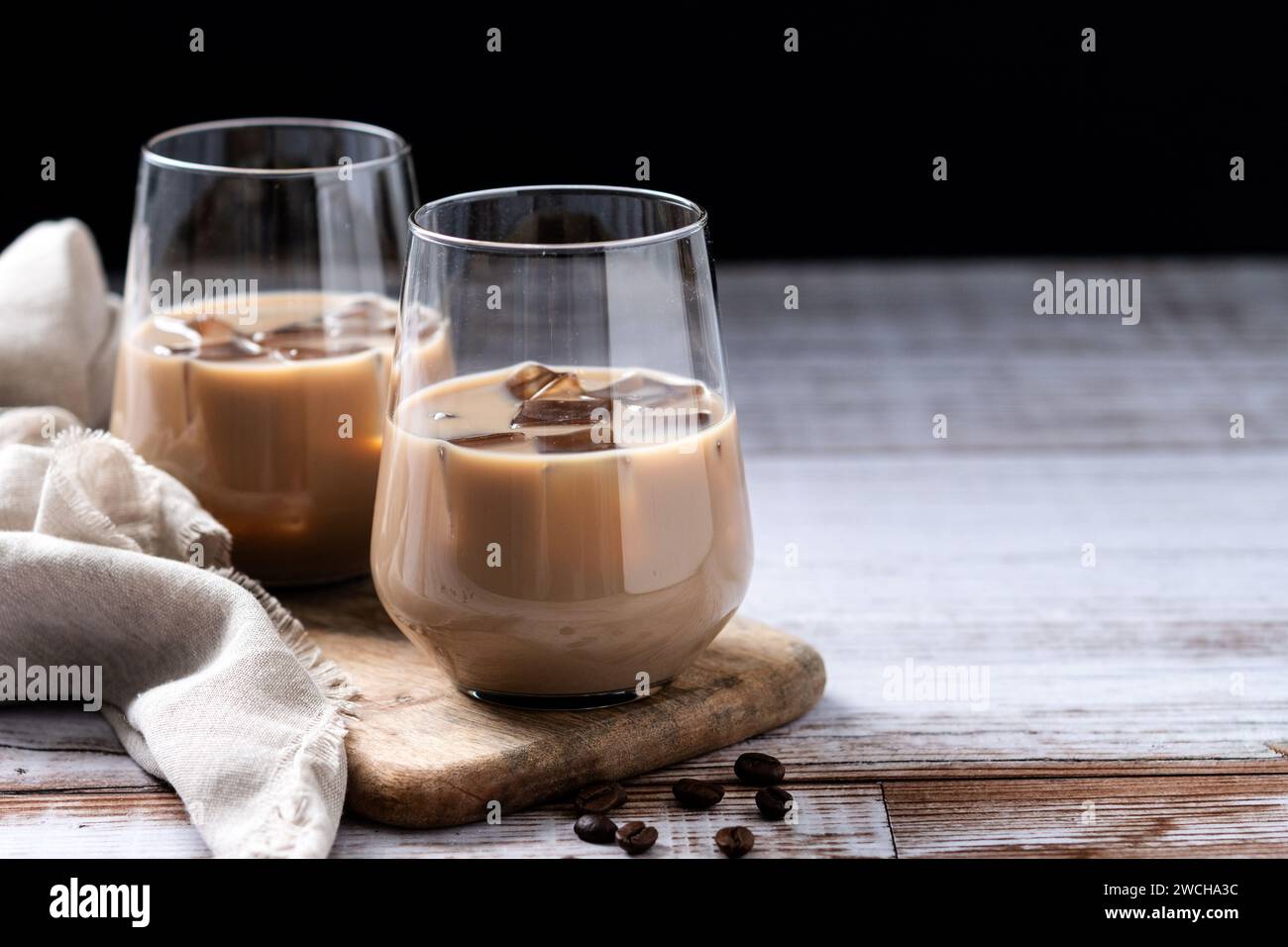 Traditional Irish cream coffee liqueur with ice on wooden table Stock ...