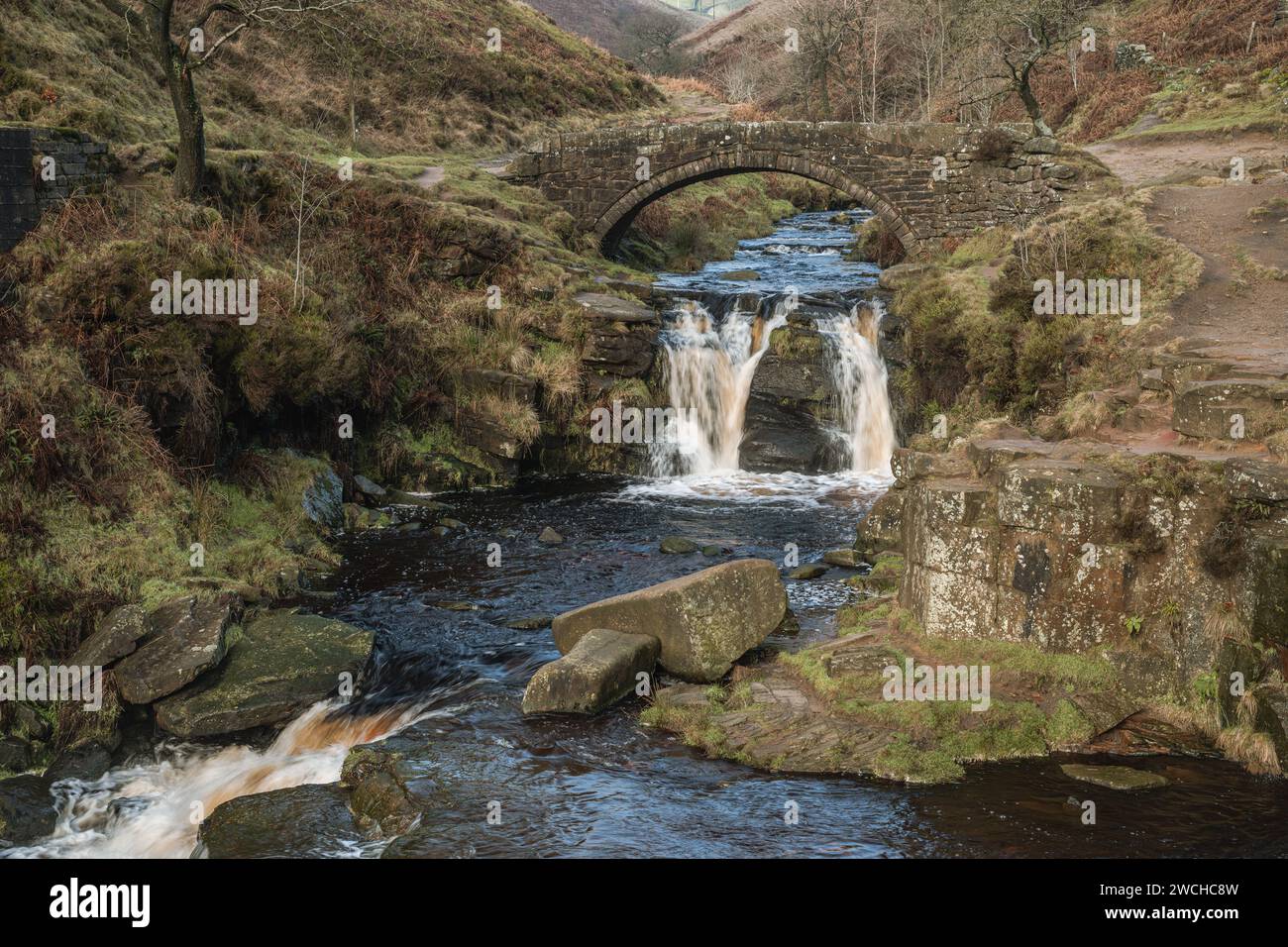 A rural winter landscape scene of the waterfall and packhorse stone ...