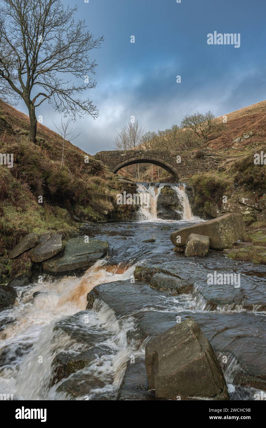 A rural winter landscape scene of the waterfall and packhorse stone ...