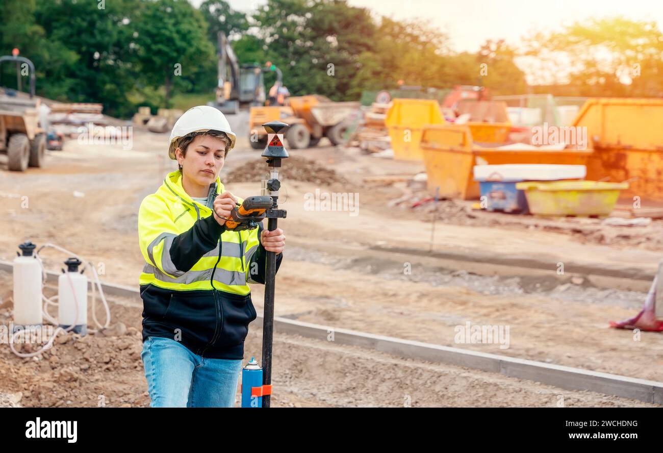 Female site engineer surveyor working with theodolite total station EDM ...