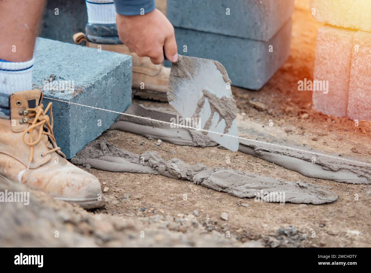 Bricklayer laying high-density footing concrete blocks Stock Photo - Alamy