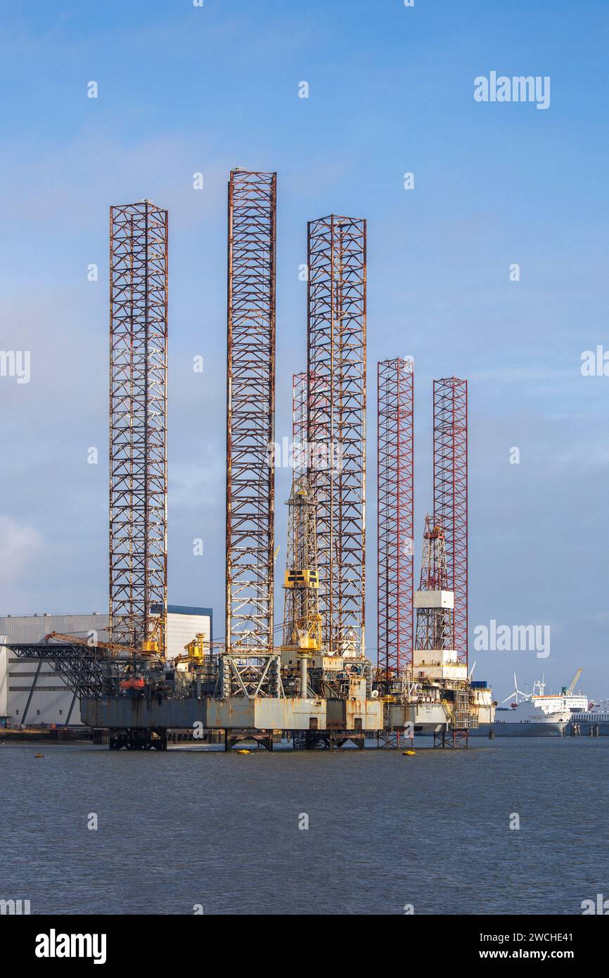 an old disused oil drilling rig is being dismantled in the harbor of ...