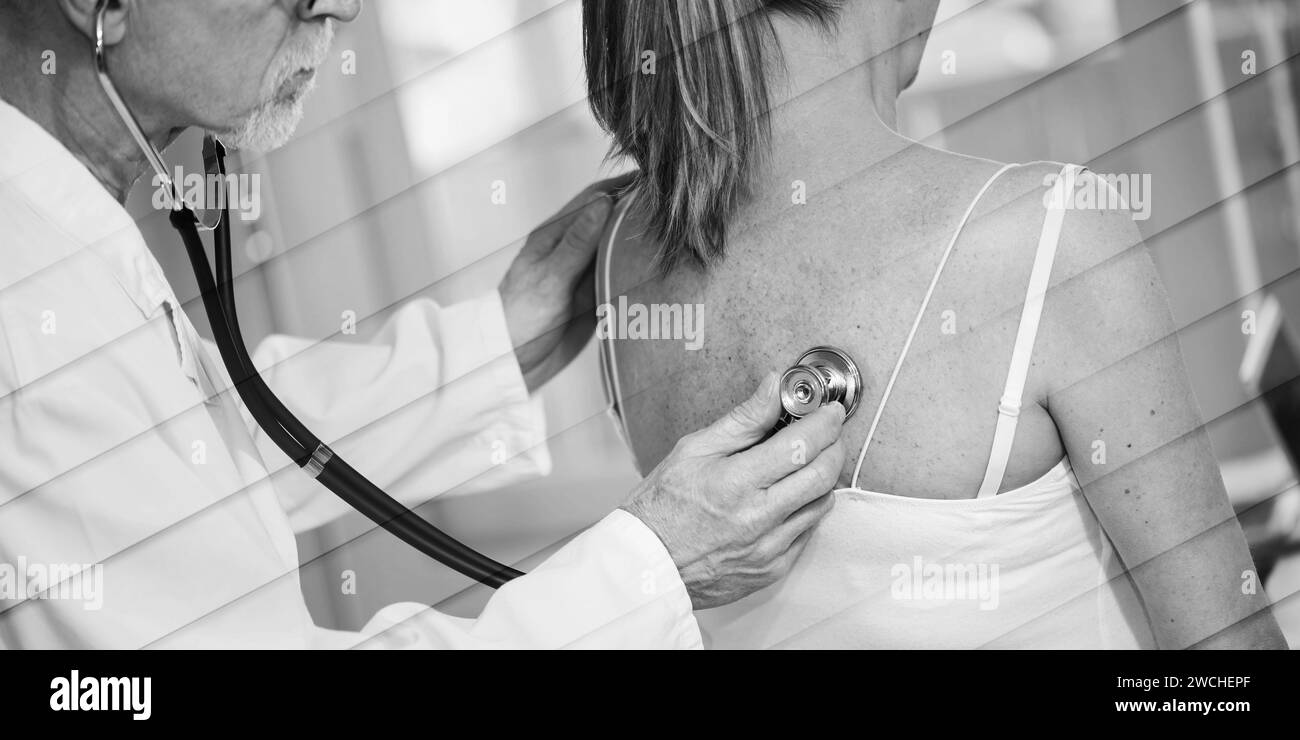 Senior doctor auscultating his female patient with stethoscope ...