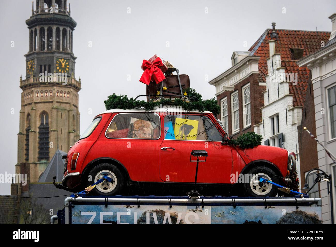a Mini Cooper decorated for Christmas stands on a container at Damplein ...