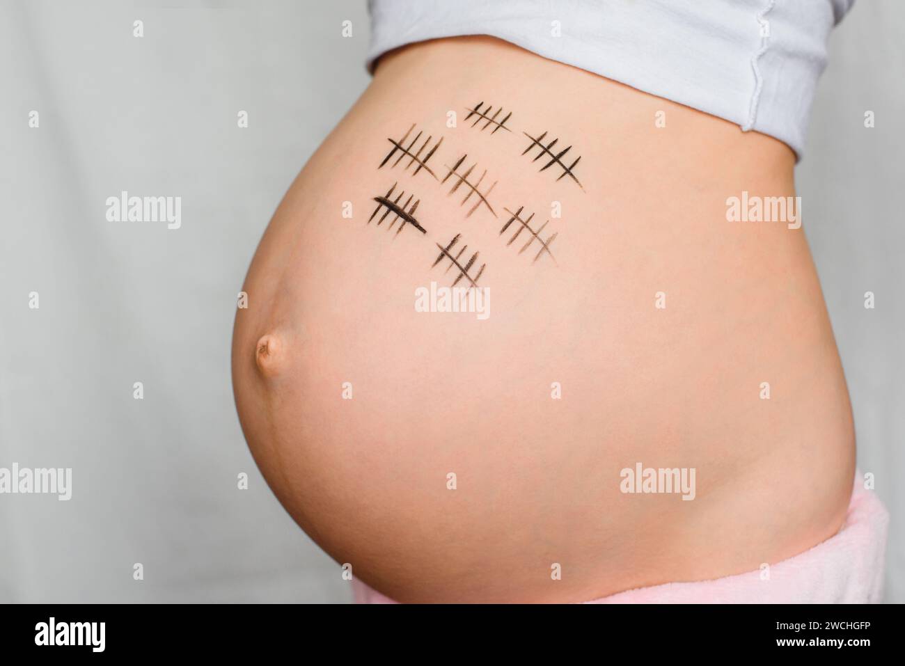 belly of a pregnant girl with painted paints for a period of pregnancy ...