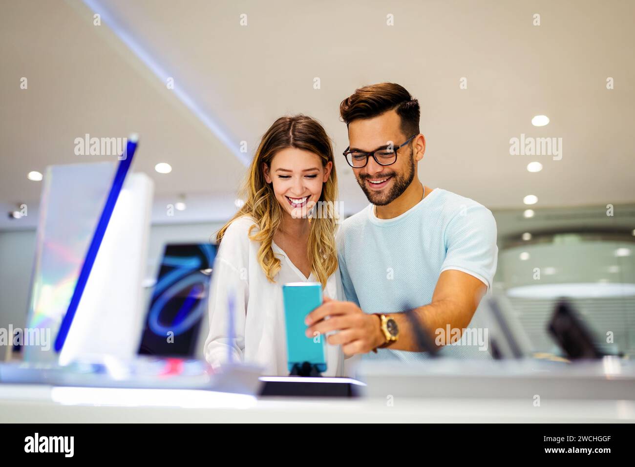 Tech shopping device gadget concept. Happy young people buying a new ...