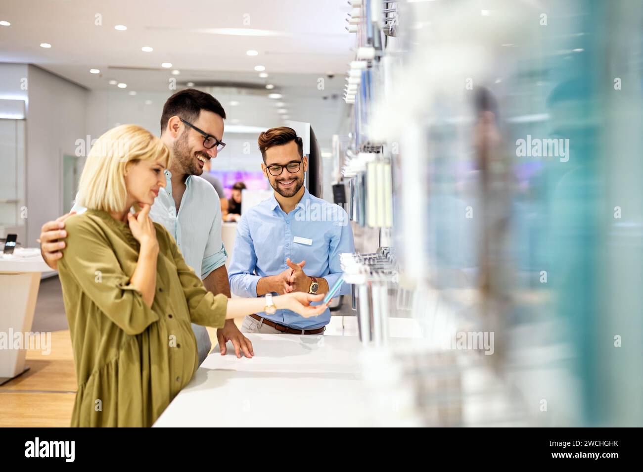 Tech shopping device gadget concept. Happy young people buying a new ...