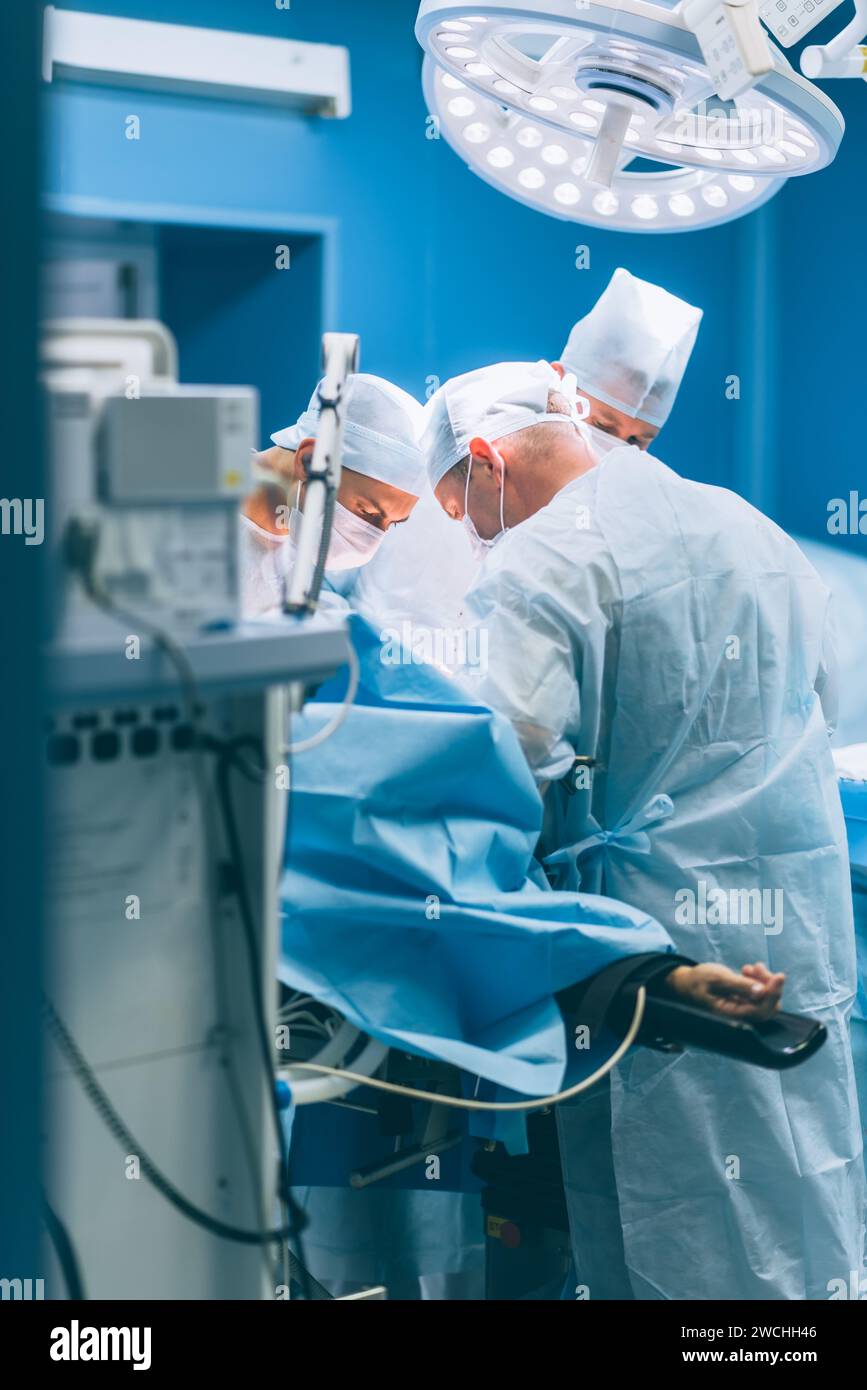 Professional surgeons performing surgery in hospital Stock Photo - Alamy