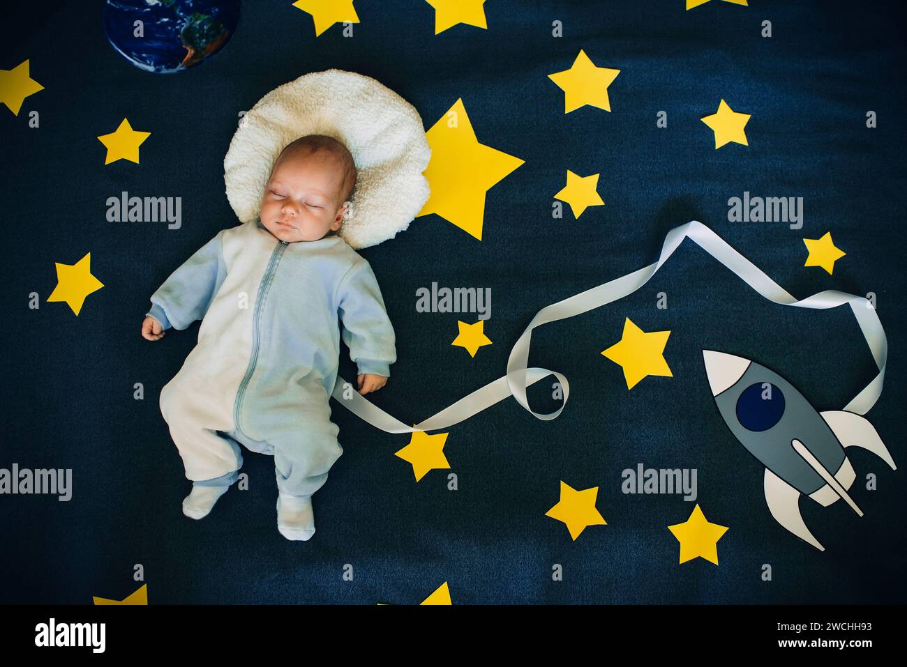 sleeping baby boy on a background of the starry sky. The concept of an ...