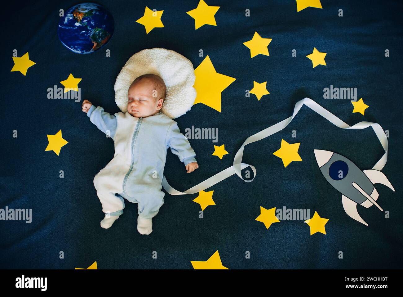 sleeping baby boy astronaut on a background of the sky with the space ...