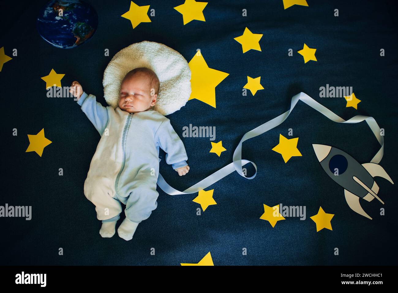 sleeping baby boy astronaut on a background of the sky with the space ...
