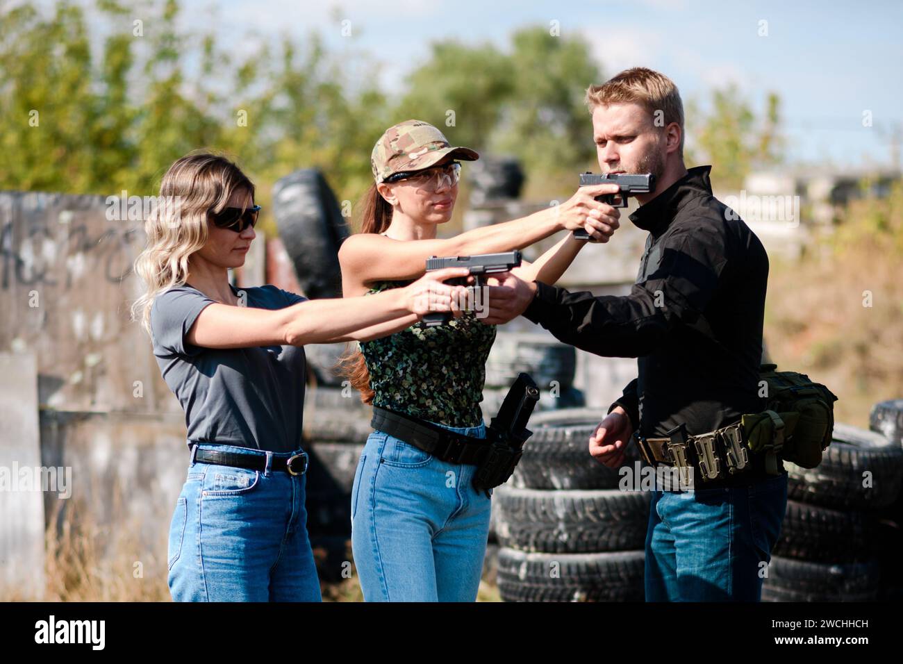 Shooting instructor teaching a women how to properly handle a weapon at ...