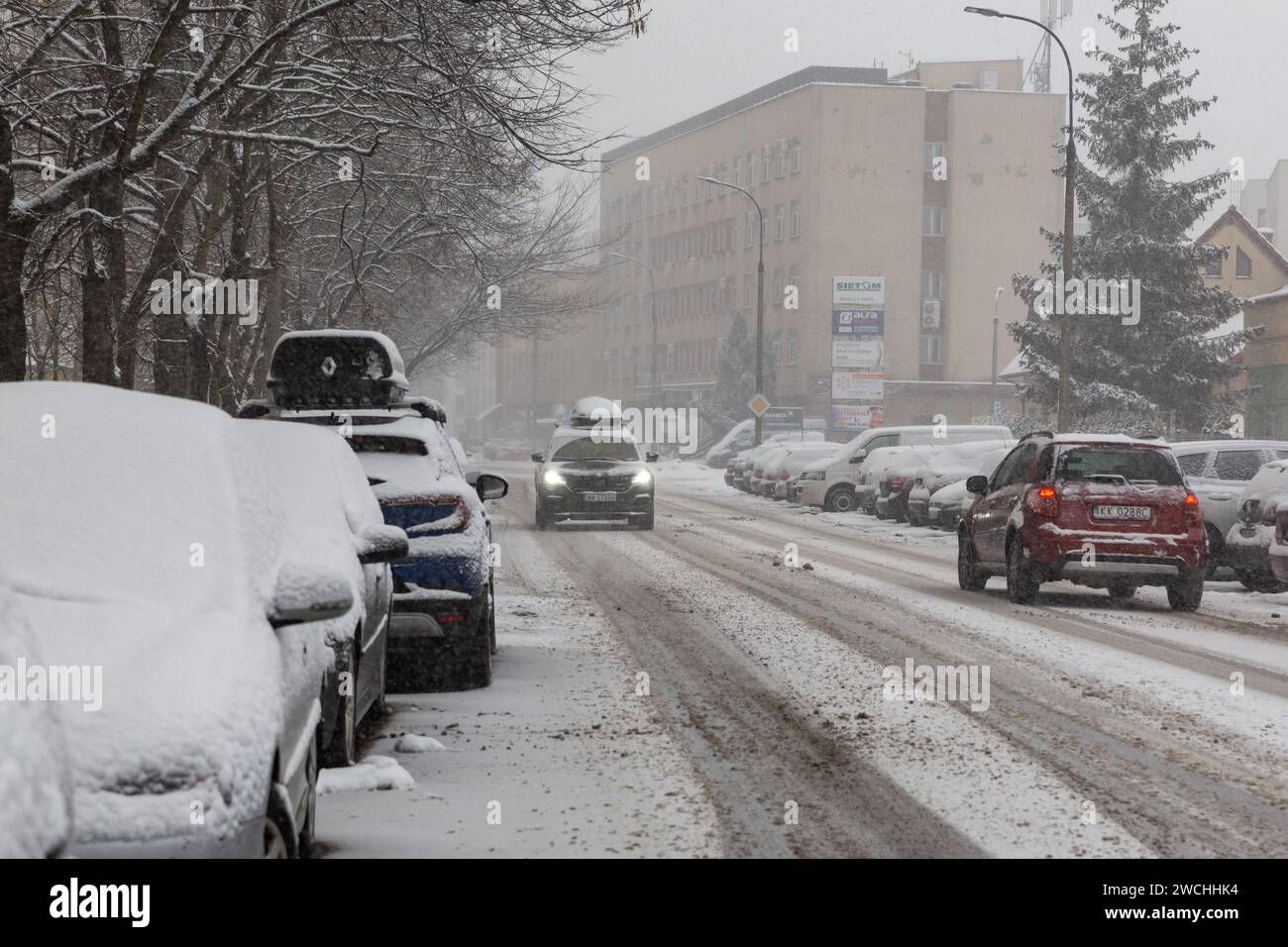 Krakow, Poland, January 16, 2024. Thick snow falls and driving ...