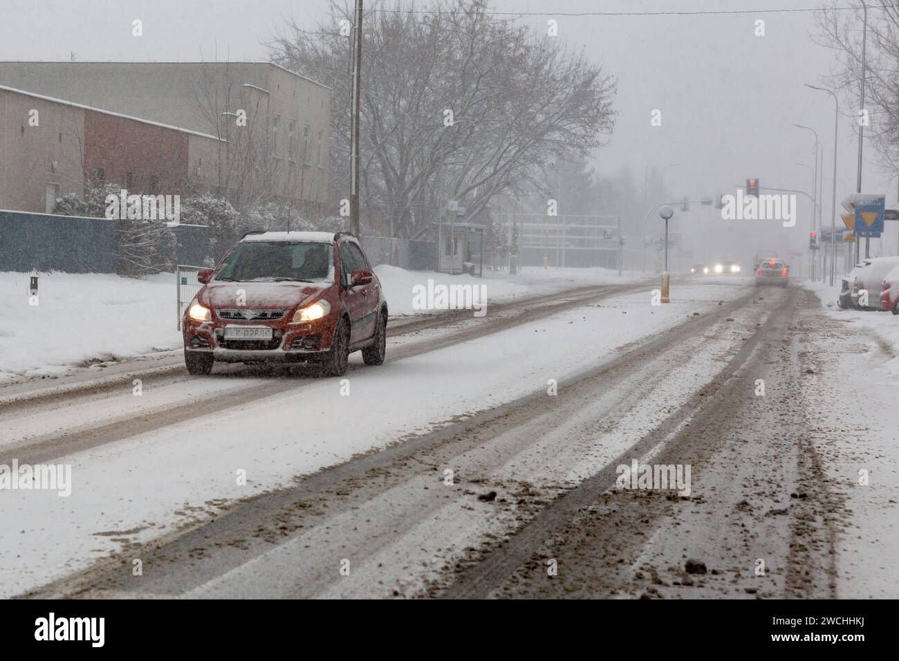 Krakow, Poland, January 16, 2024. Thick snow falls and driving ...