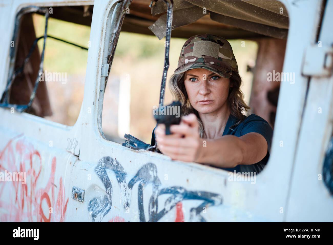 A girl with a pistol in her hand undergoes military training at a ...