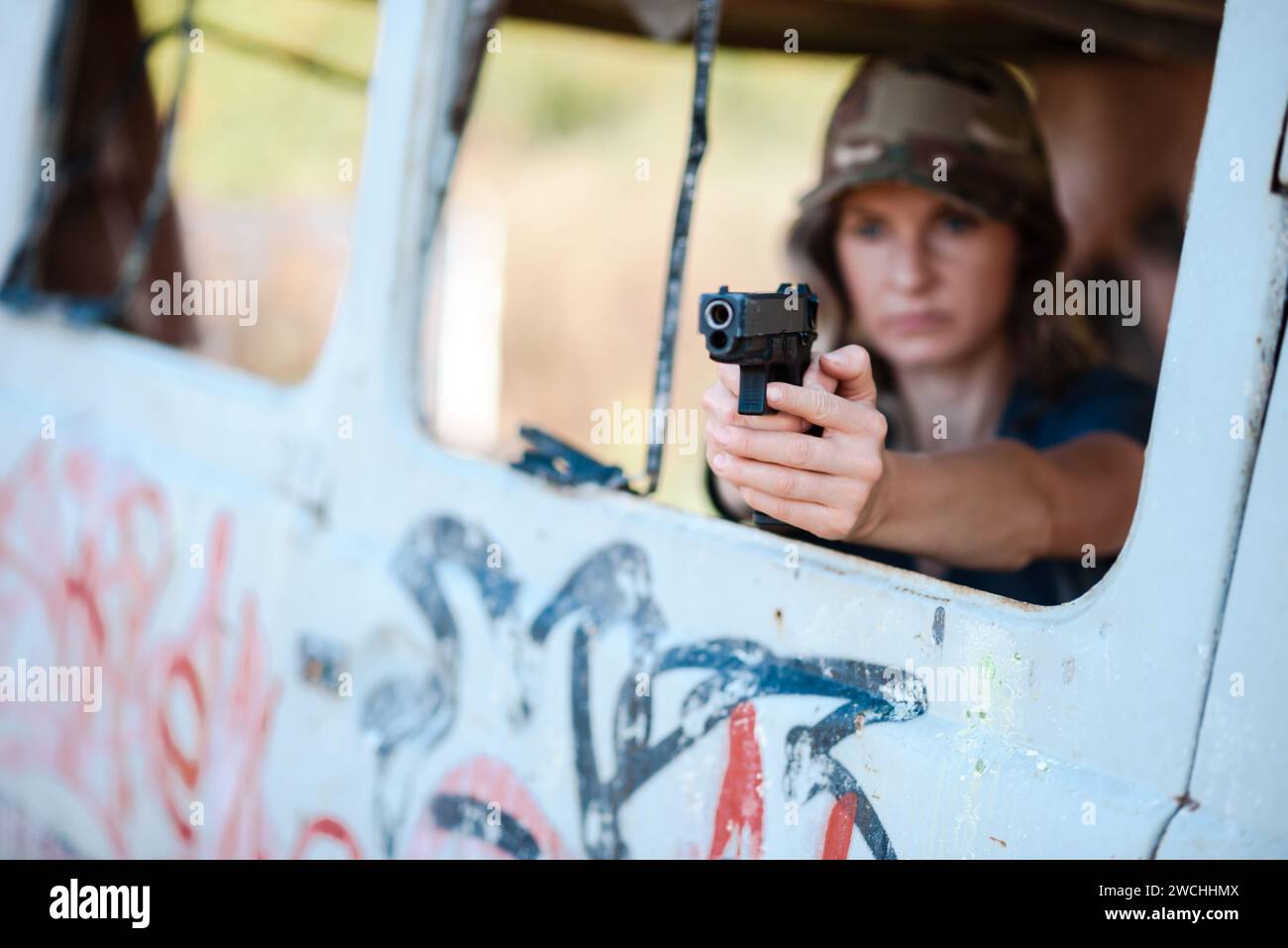A girl with a pistol in her hand undergoes military training at a ...