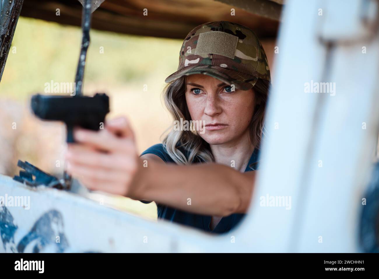 A girl with a pistol in her hand undergoes military training at a ...