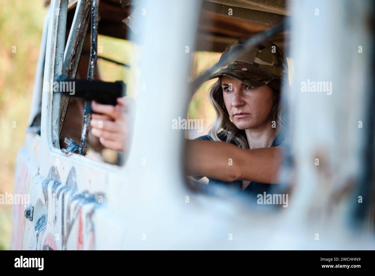 A girl with a pistol in her hand undergoes military training at a ...