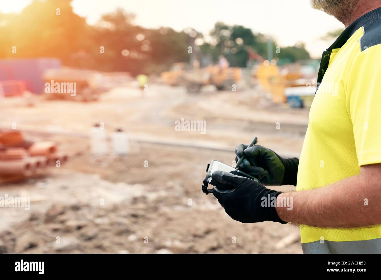 Site engineer surveyor using rugged tablet controller computer to ...