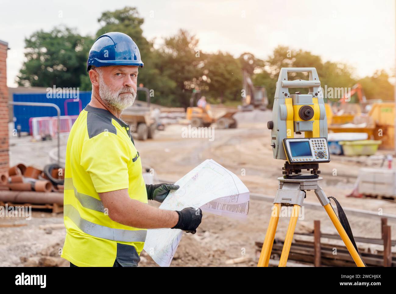 A man site engineer surveyor working with theodolite total station EDM ...