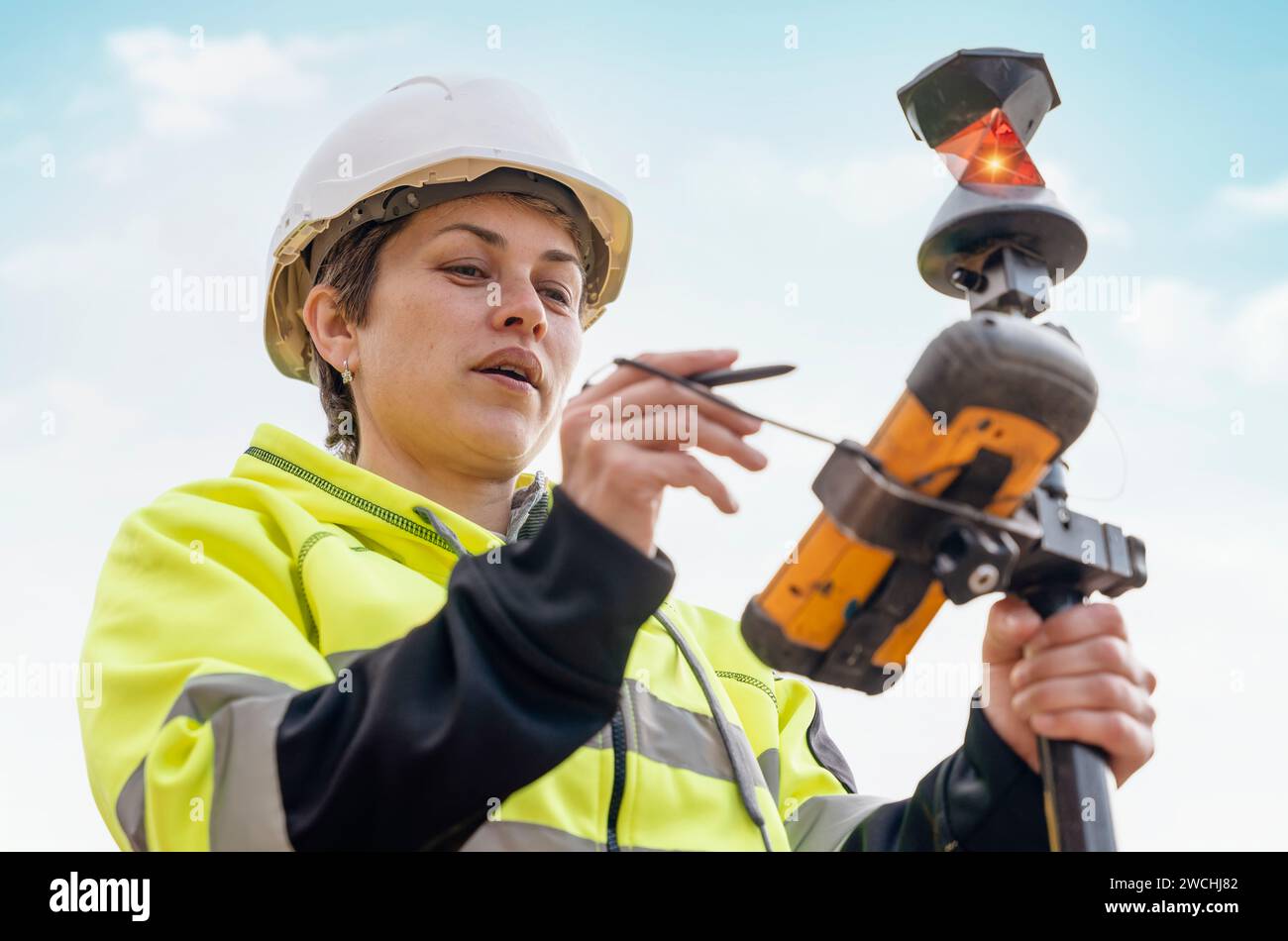 Close-up portrait of a woman site engineer surveyor working with ...
