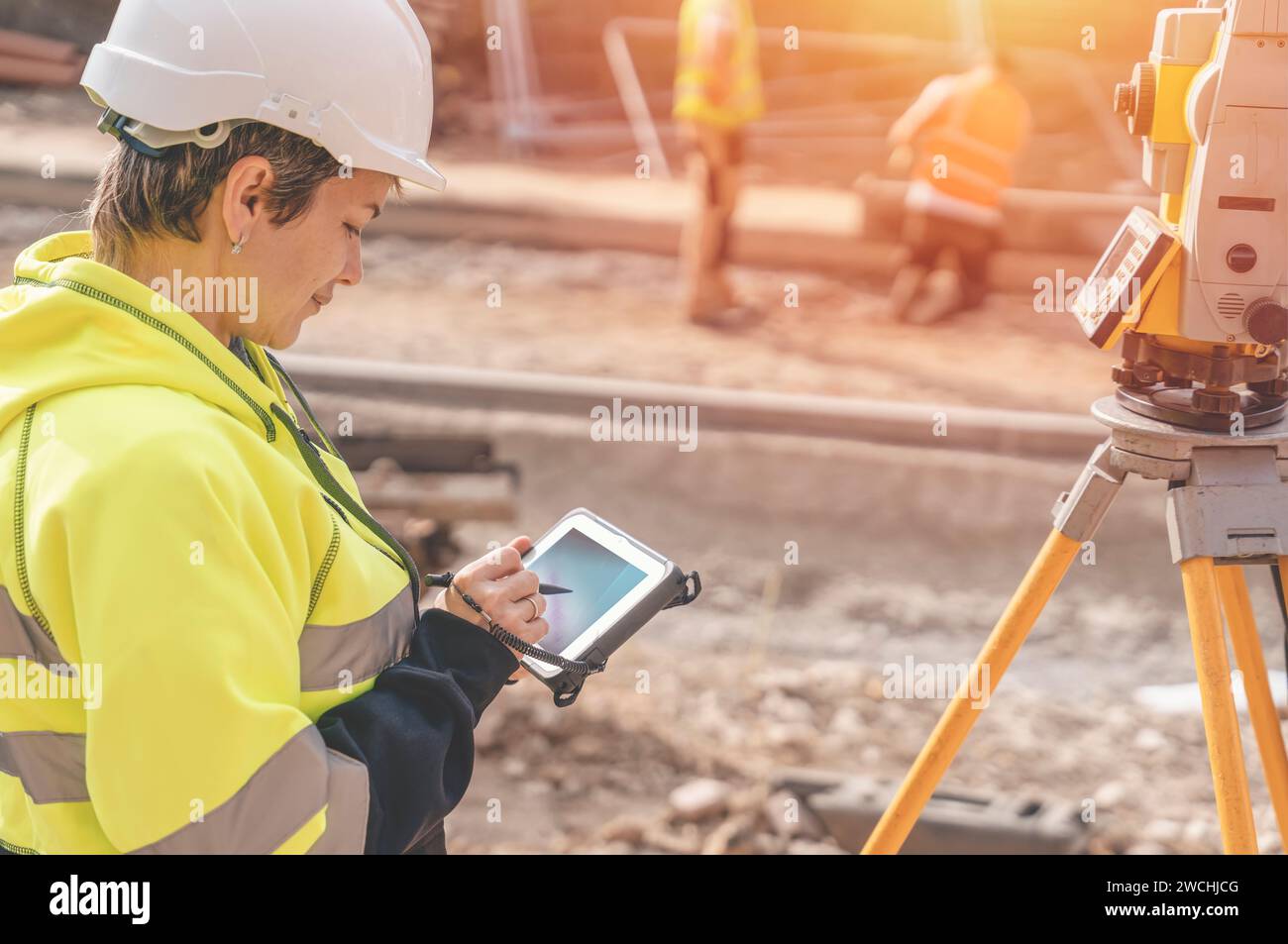 Female site engineer surveyor working with theodolite total station EDM ...