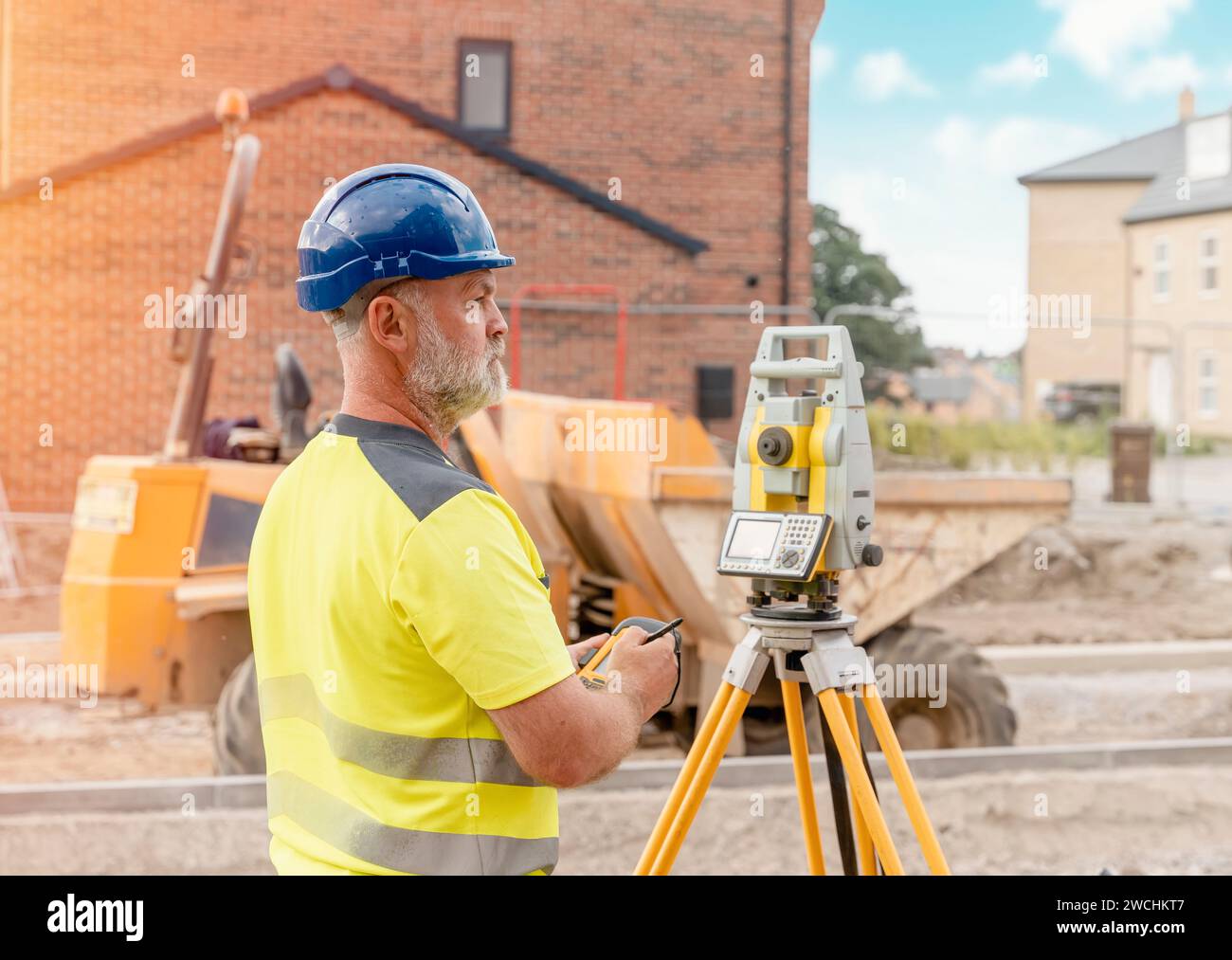 A man site engineer surveyor working with theodolite total station EDM ...