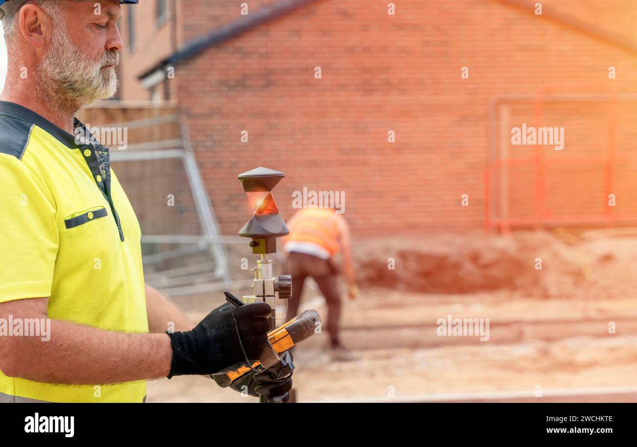 Site engineer surveyor using rugged tablet controller computer to ...
