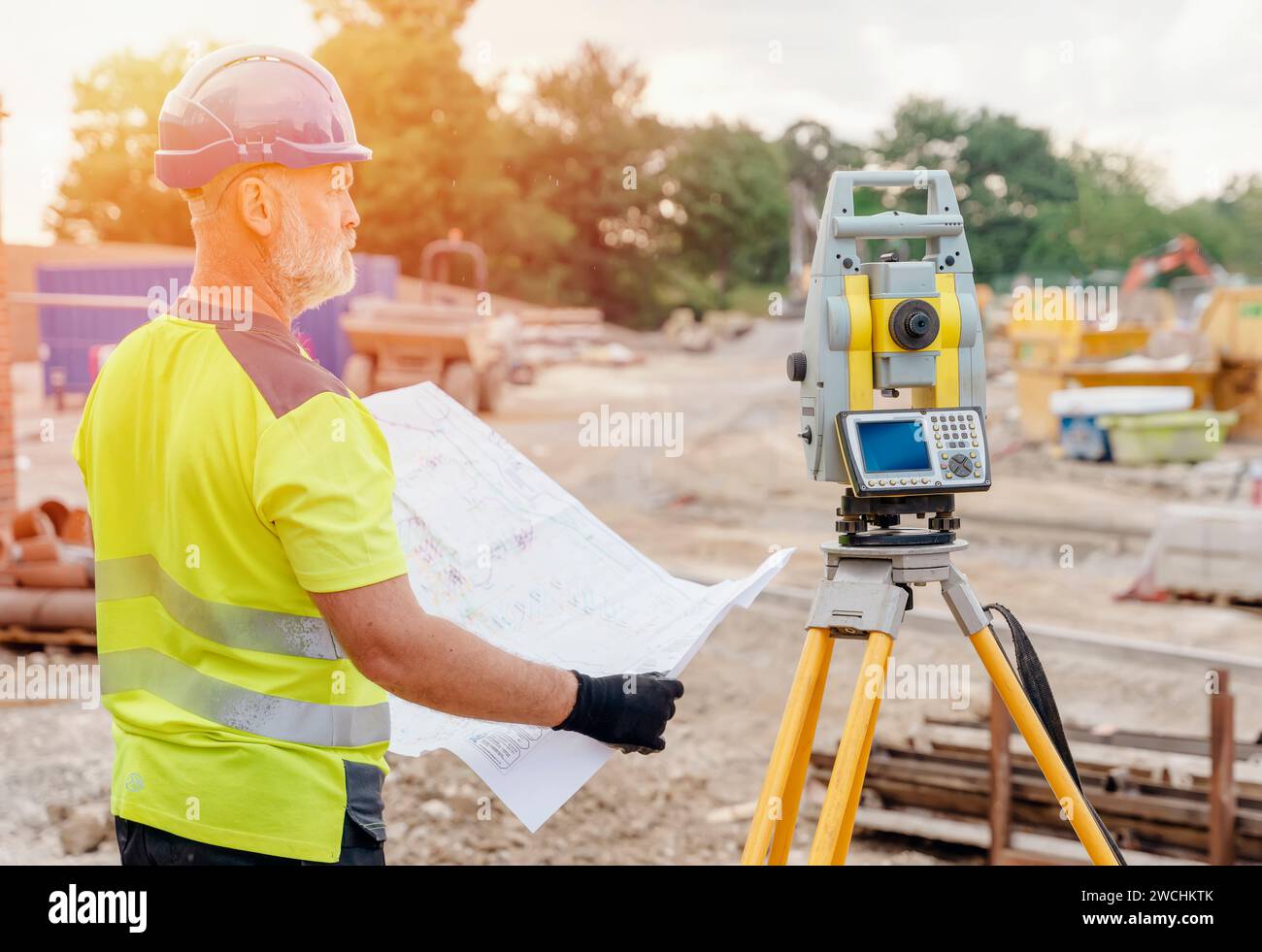 A man site engineer surveyor working with theodolite total station EDM ...