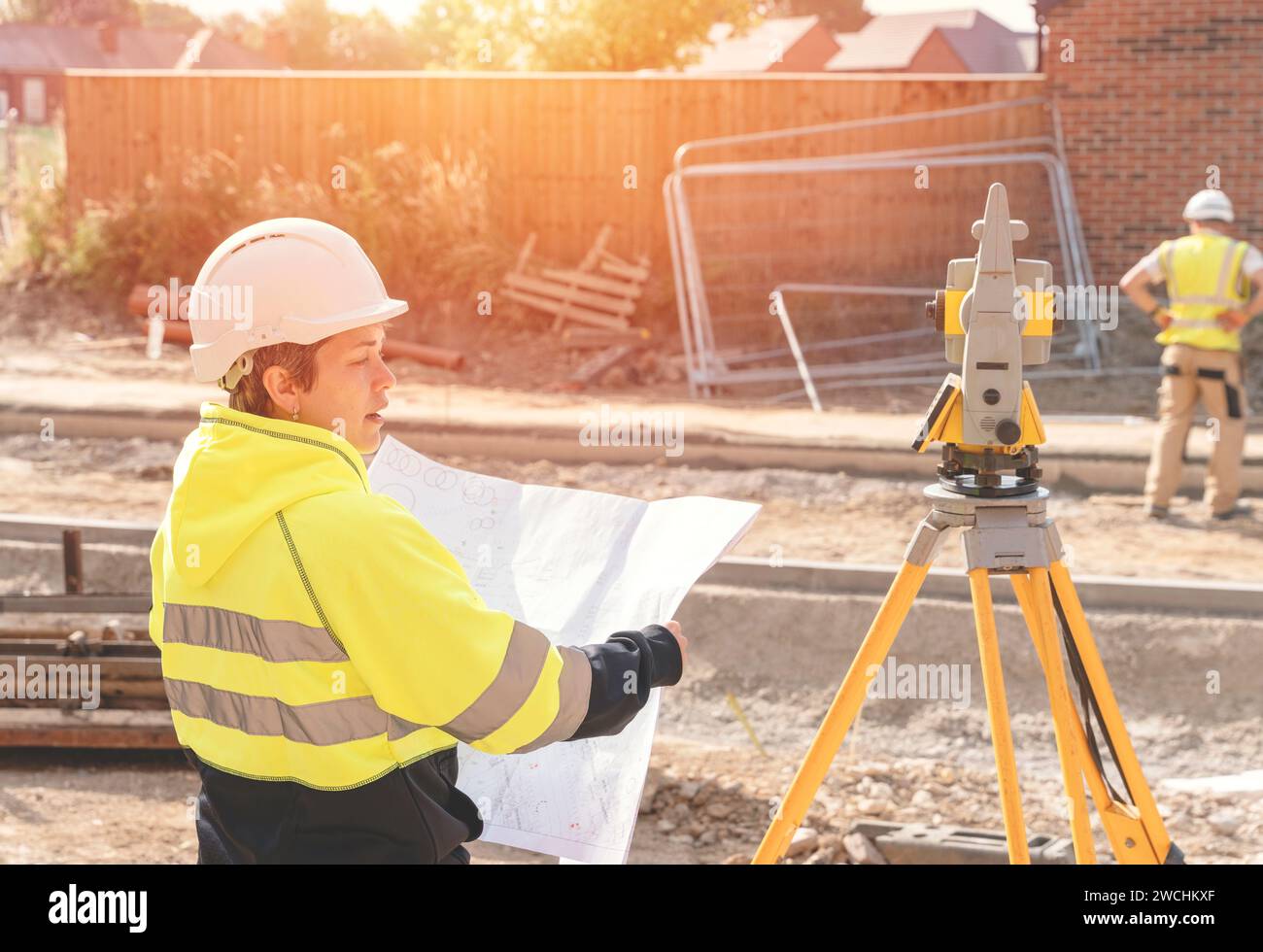 Female site engineer surveyor working with theodolite total station EDM ...
