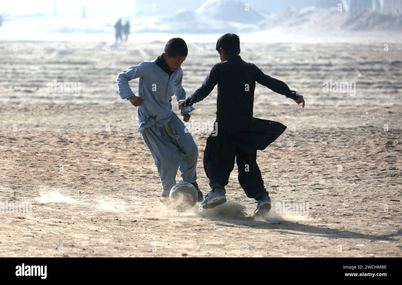 (240116) -- KABUL, Jan. 16, 2024 (Xinhua) -- Afghan boys play football in the cold weather on a ...