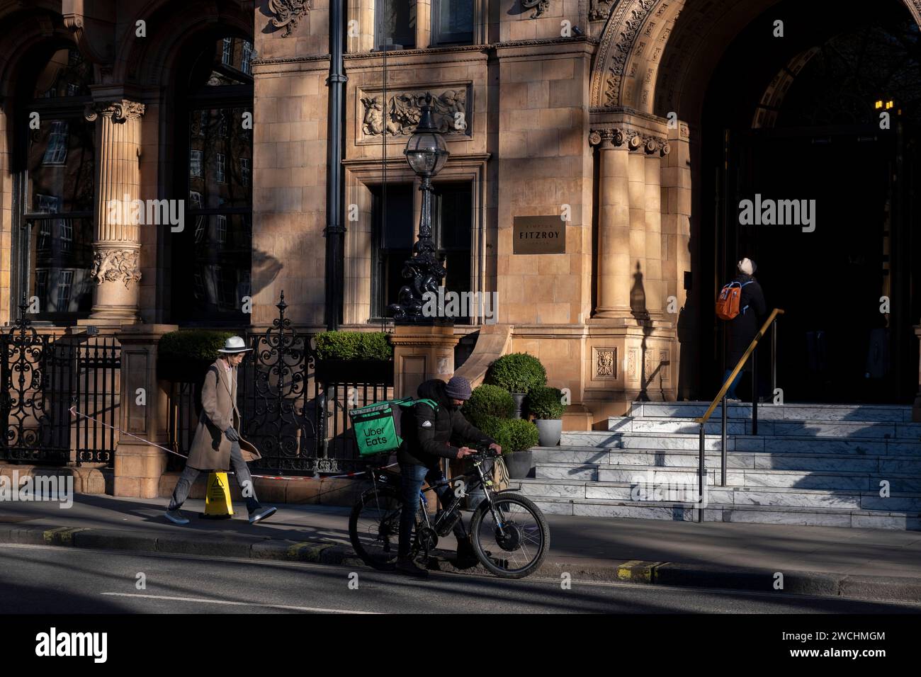 Uber Eats rider outside the Kimpton Fitzroy Hotel on 15th January 2024 ...
