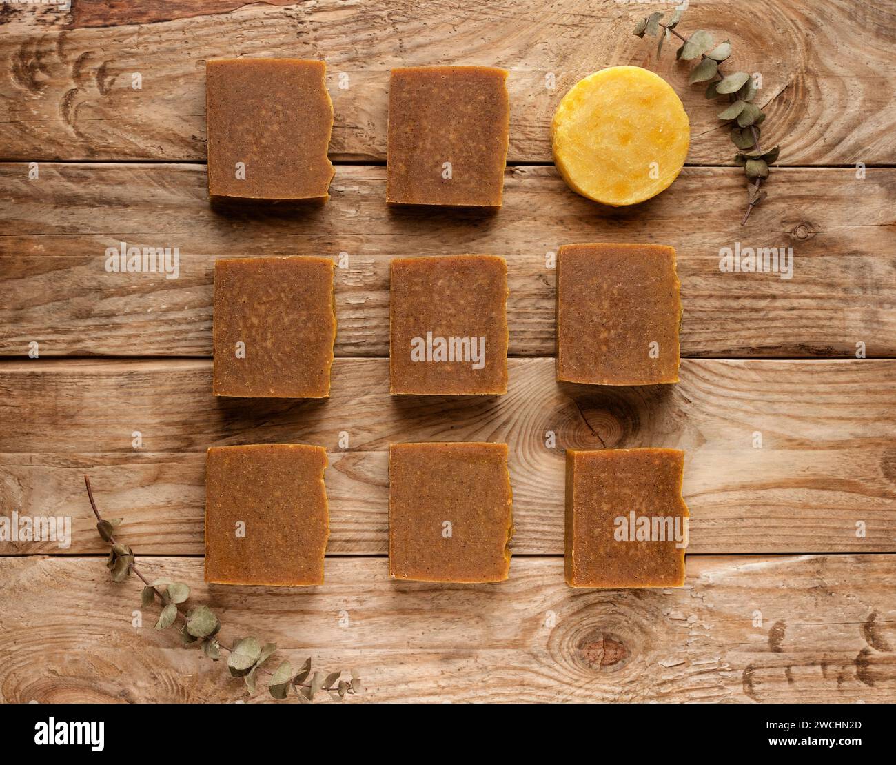 Handmade organic soap bars in square and circle shapes on wooden table ...
