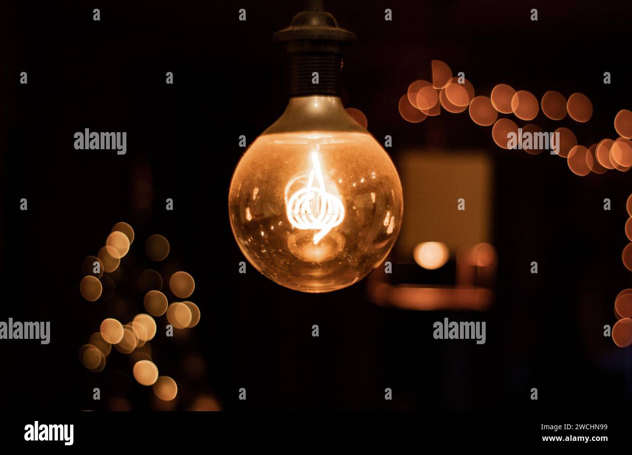 Tungsten lamp with a bokeh background design Stock Photo - Alamy