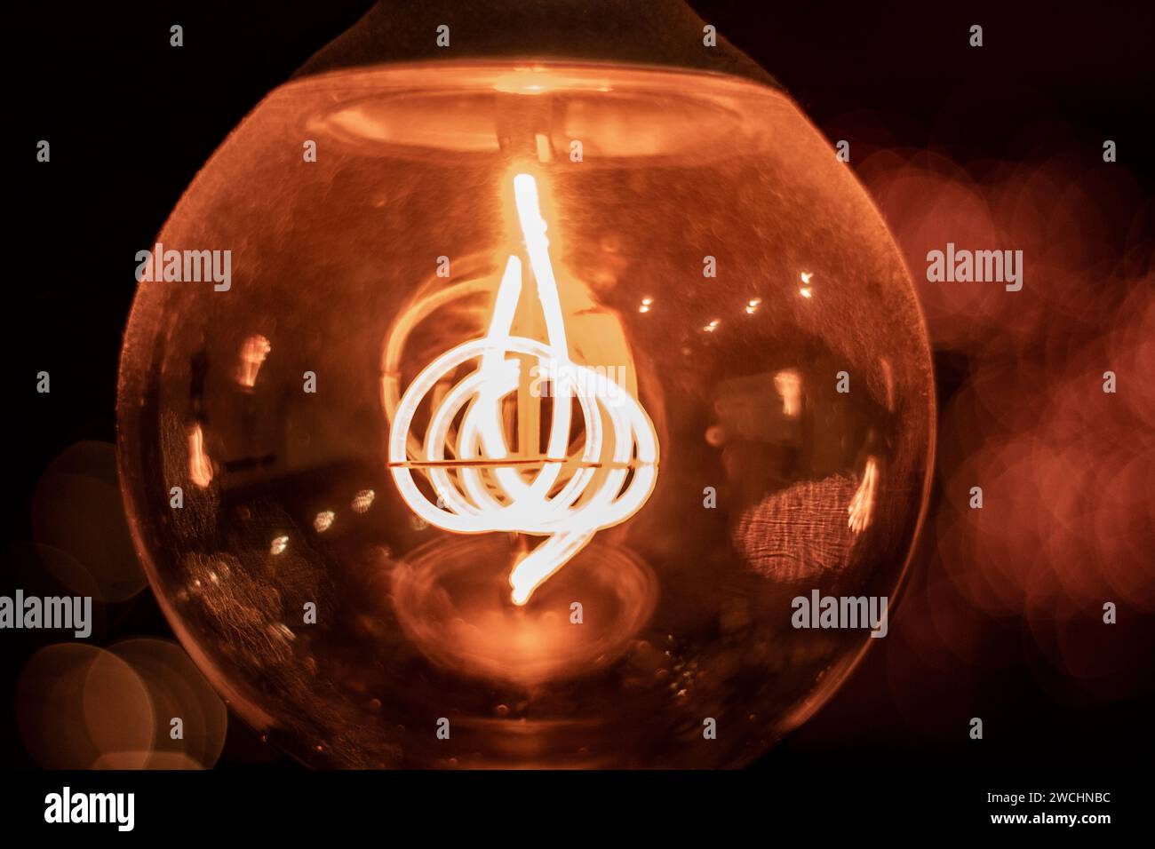 Tungsten lamp with a bokeh background design Stock Photo - Alamy